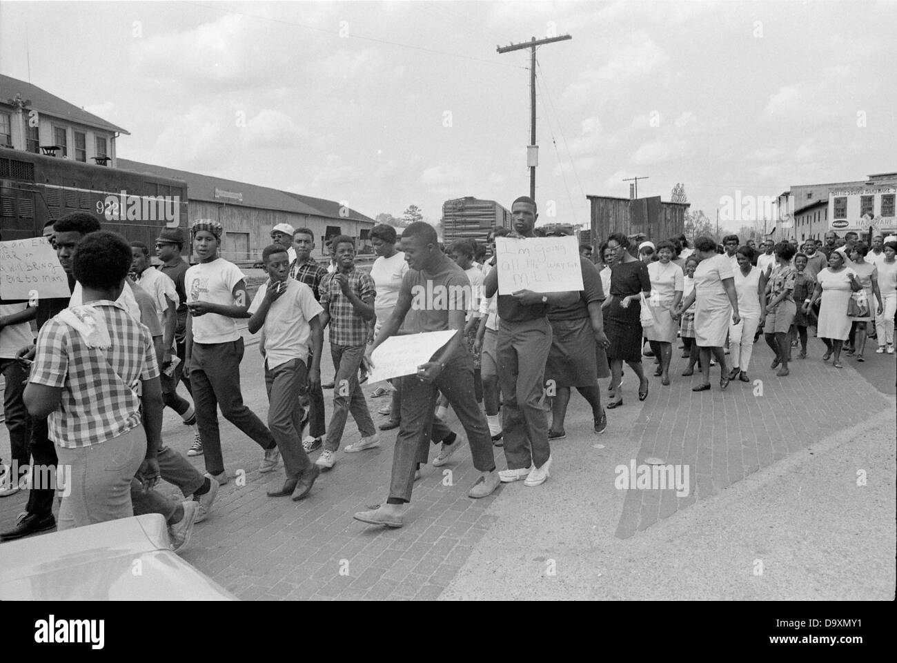 The image shows a historical march involving Dr. Martin Luther King Jr ...