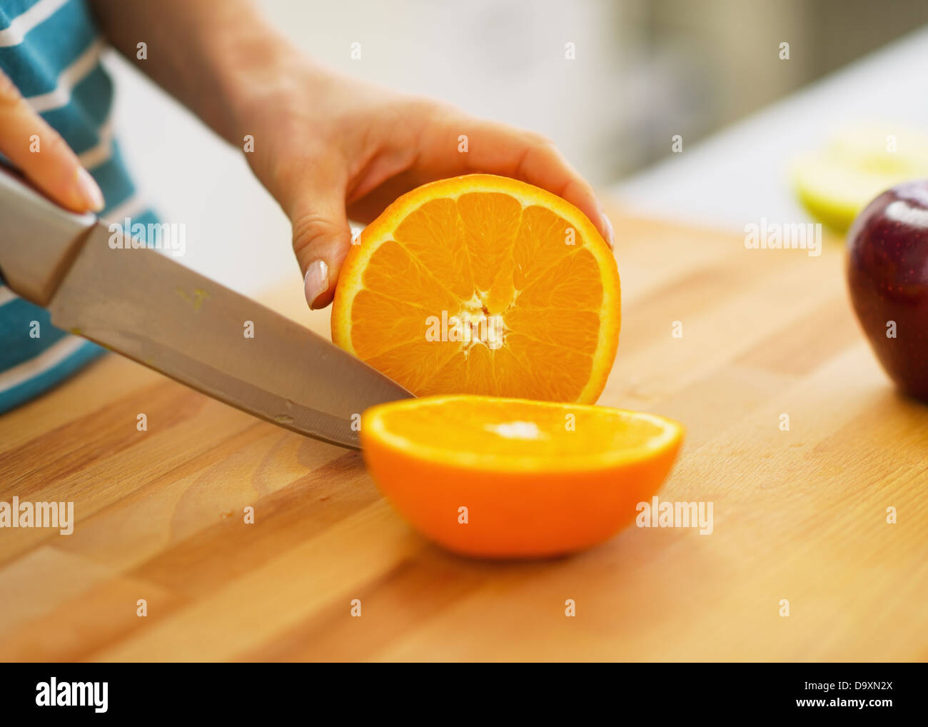 Closeup on woman cutting orange Stock Photo - Alamy