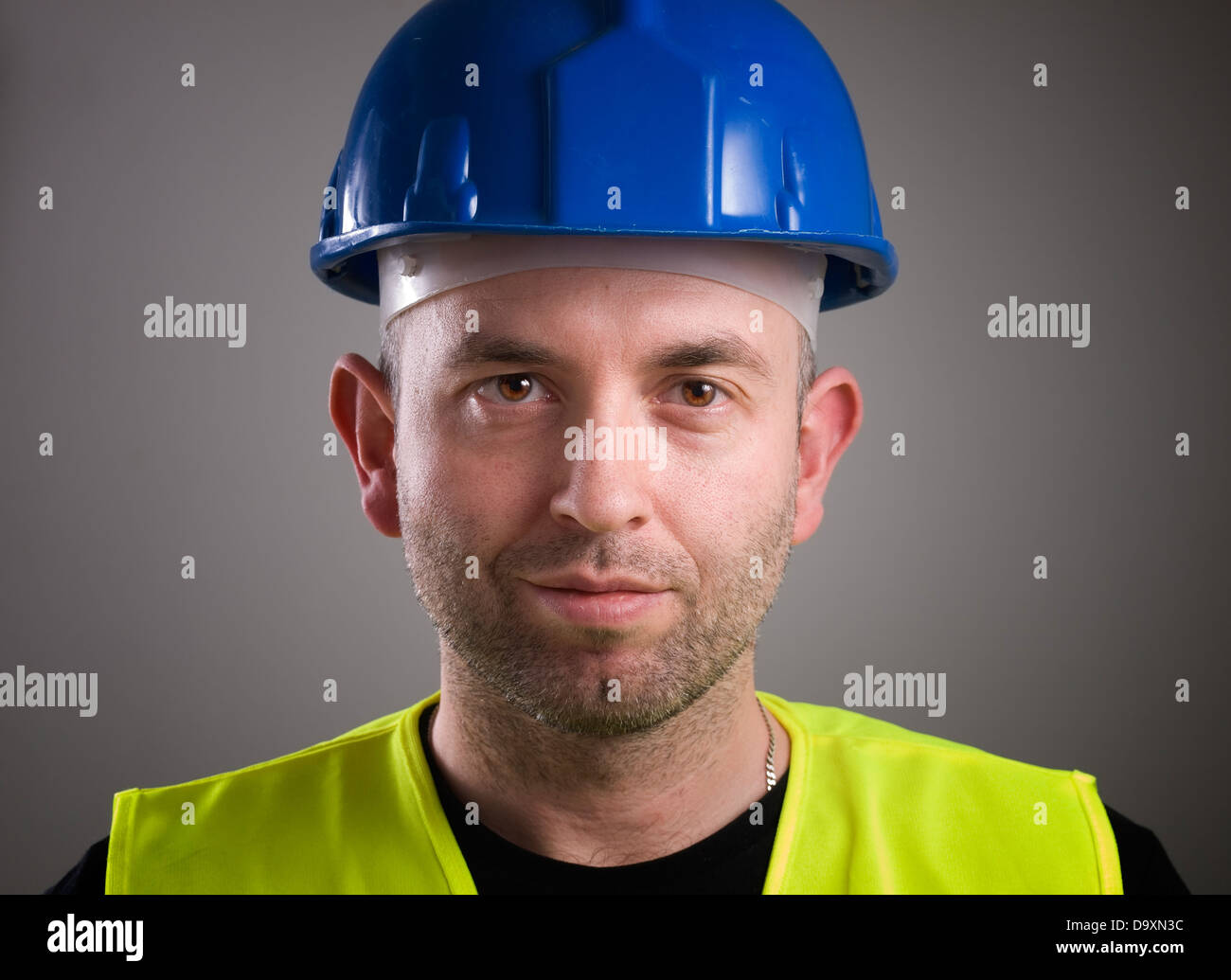 Worker man portrait isolated on dark background Stock Photo - Alamy