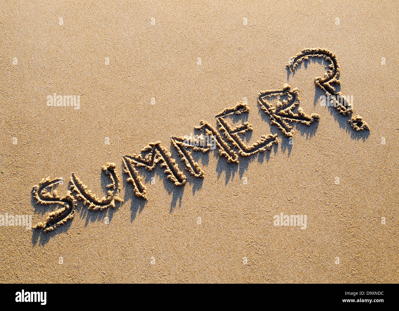 Word summer written in the sand with a question mark. The text is ...