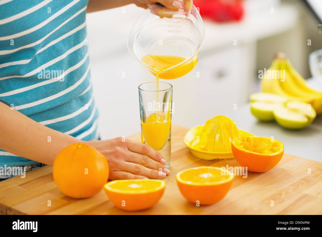 Closeup on woman pouring juice into glass Stock Photo - Alamy