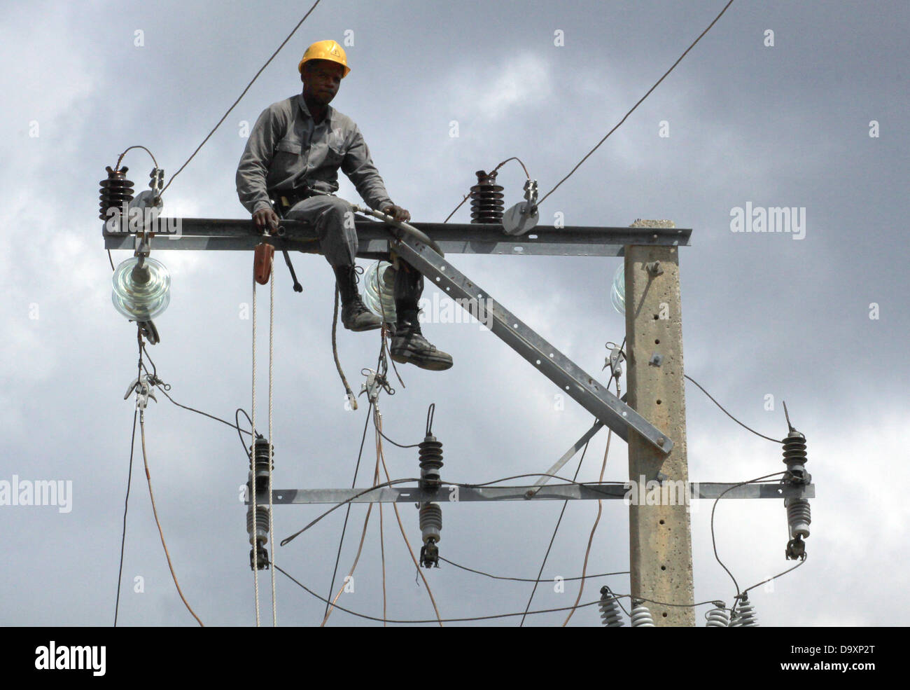 An electrician works on power lines in a street in Trinidad, Cuba, 15 ...