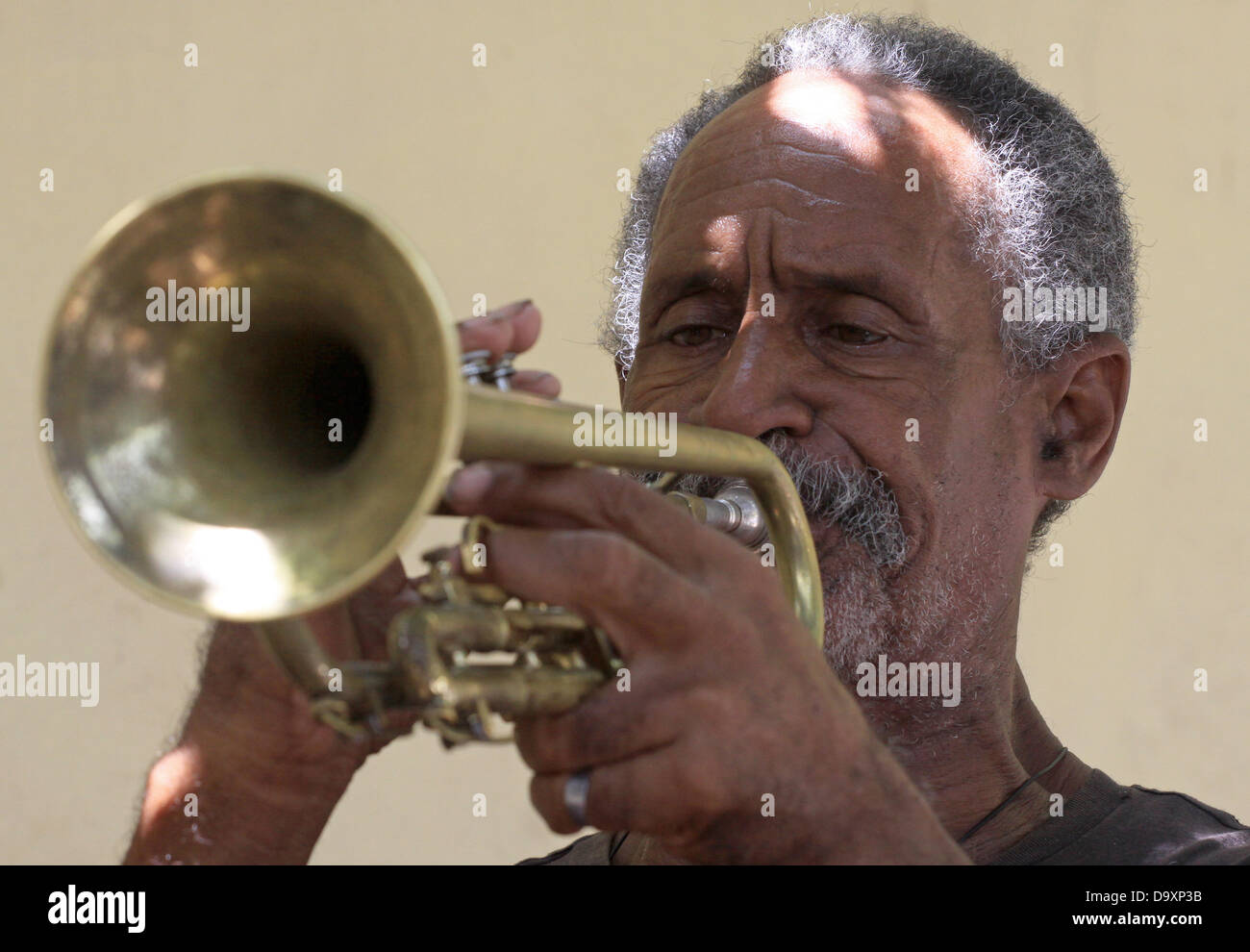 A man plays traditional Cuban music with a local instrument at the old ...