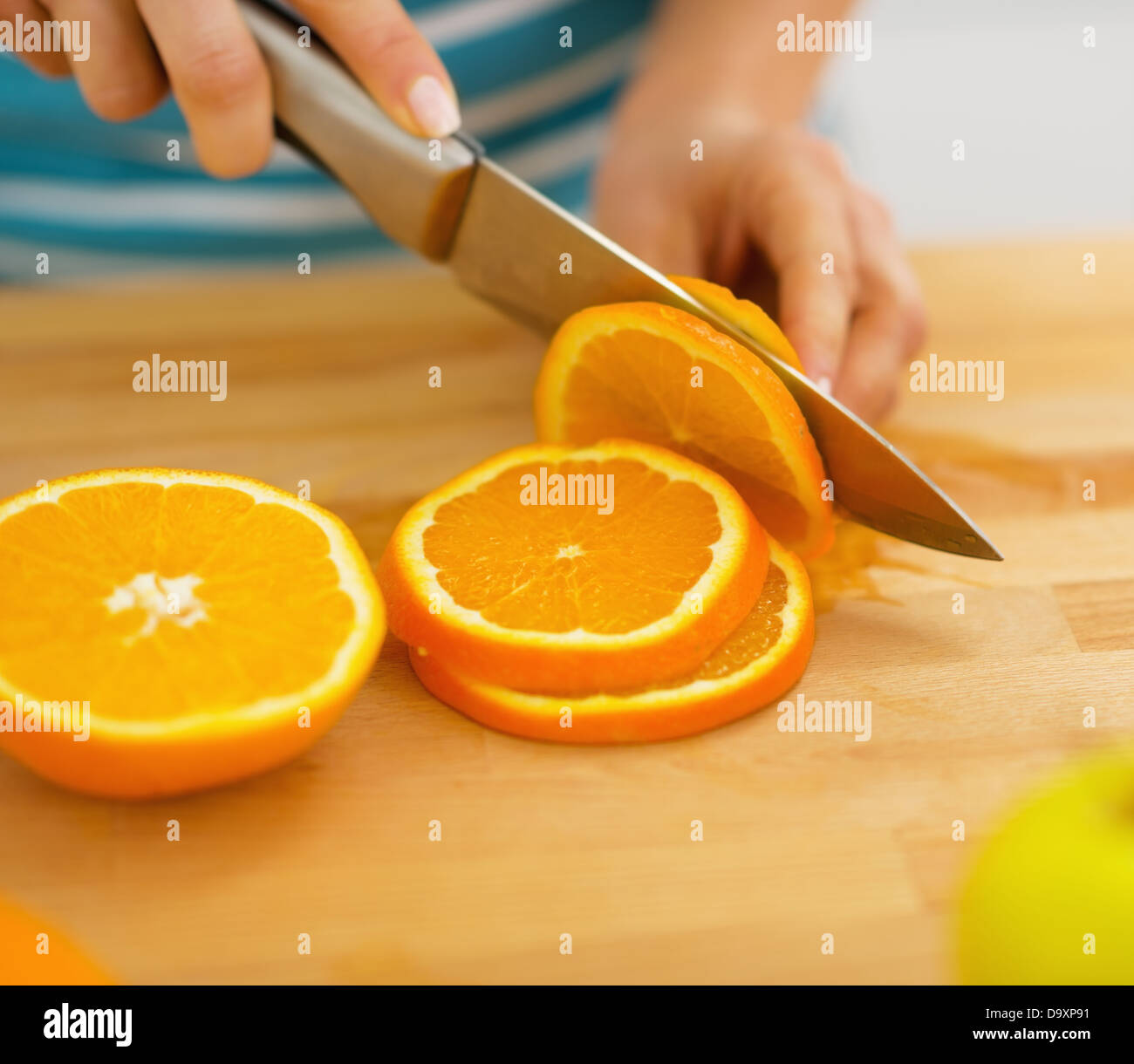 Closeup on woman cutting orange Stock Photo - Alamy