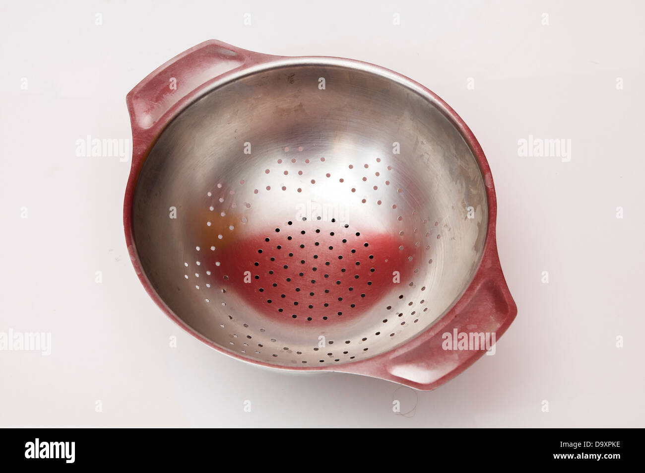 large colander over a white background Stock Photo - Alamy