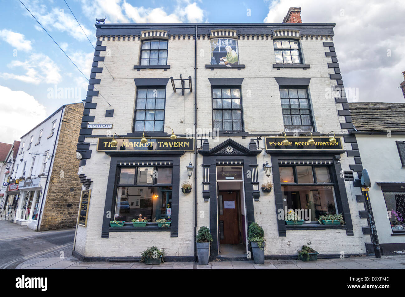 An old market town pub with a painted-in middle upper storey window of ...
