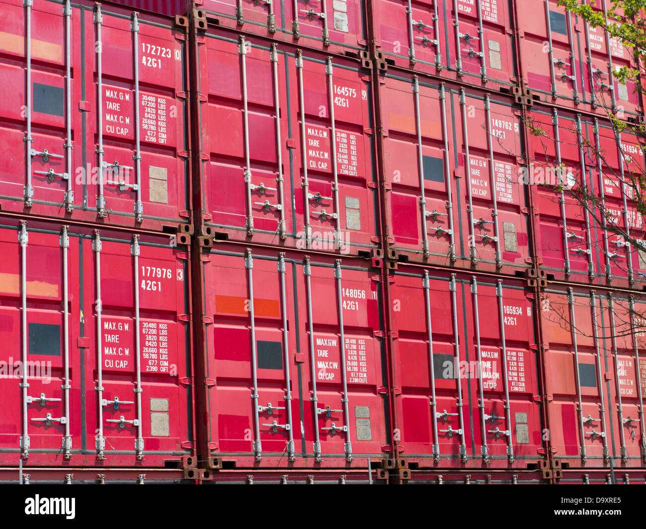 red cargo containers on a large storage area in the Rotterdam harbor ...