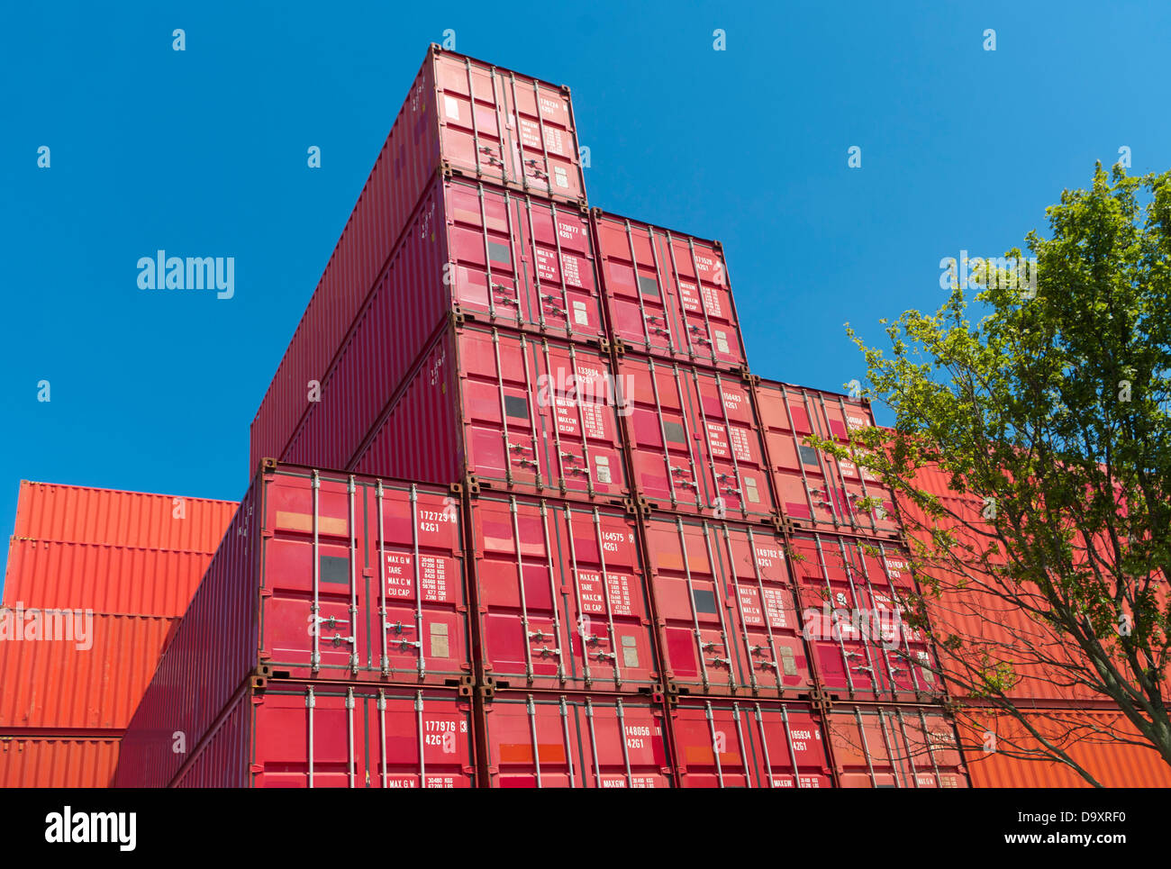 red cargo containers on a large storage area in the Rotterdam harbor ...