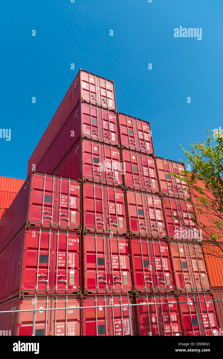 red cargo containers on a large storage area in the Rotterdam harbor ...