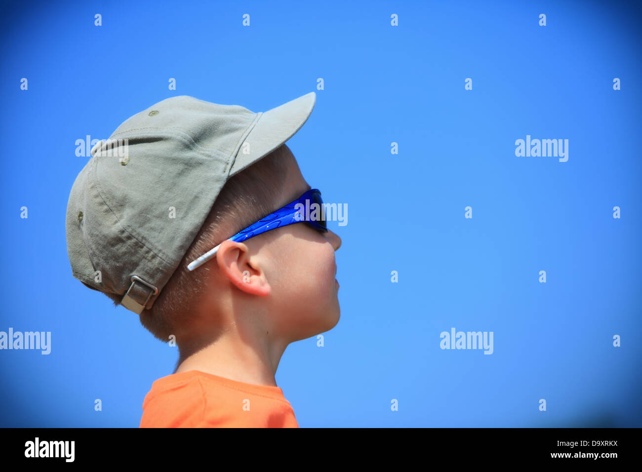Little boy kid with sunglasses and cap outdoor sky background Stock ...