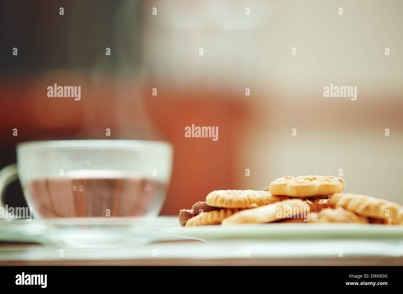 Cup of water and cookies Stock Photo - Alamy