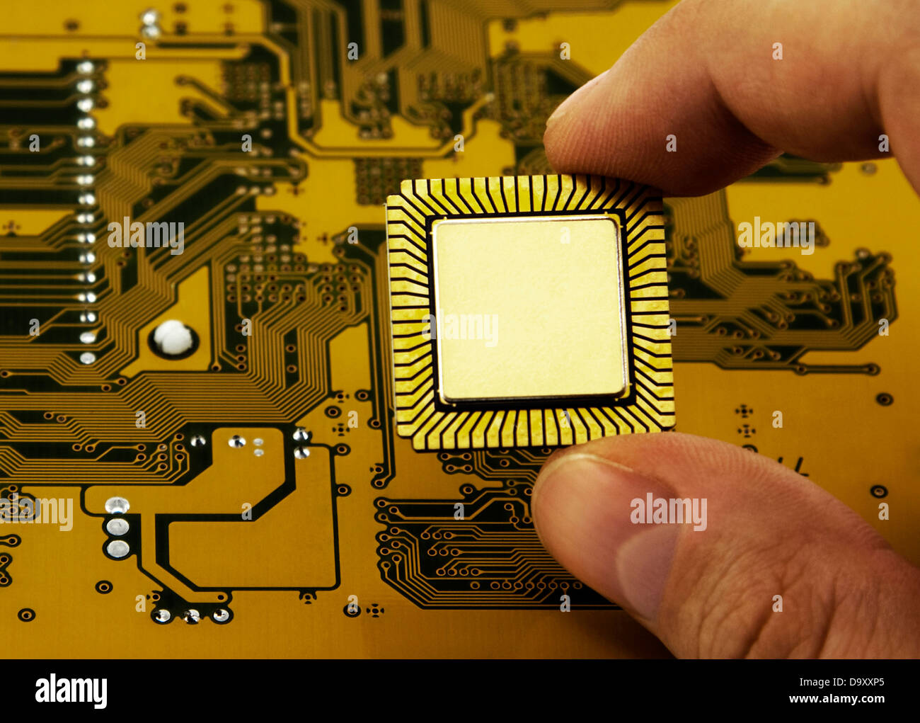 Fingers holding a CPU Stock Photo - Alamy