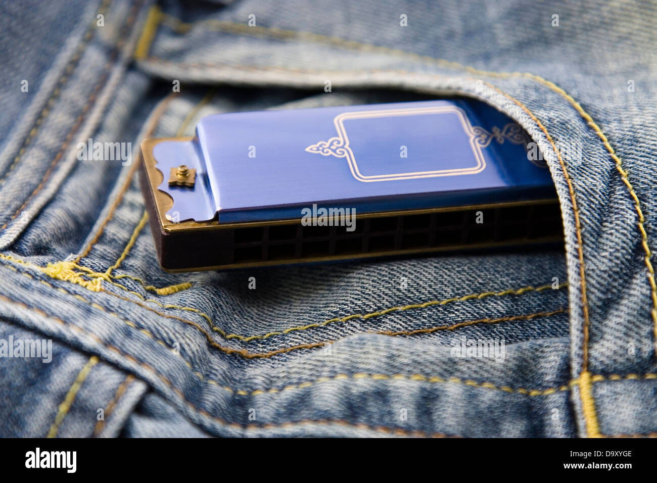Blue harmonica in pocket Stock Photo - Alamy