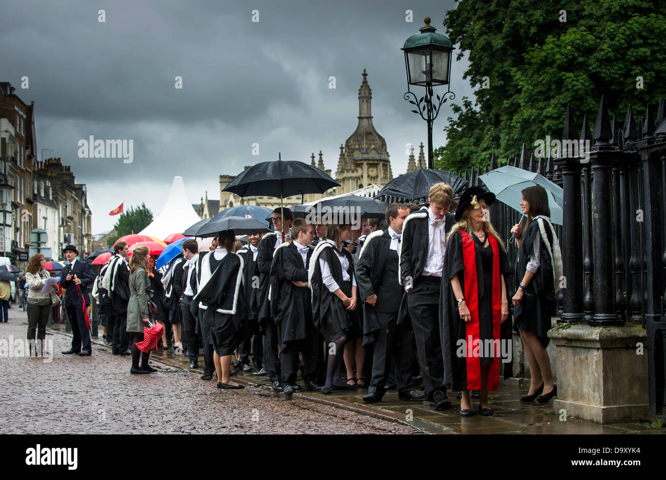 Students and their family and friends queue outside the Senate house in ...