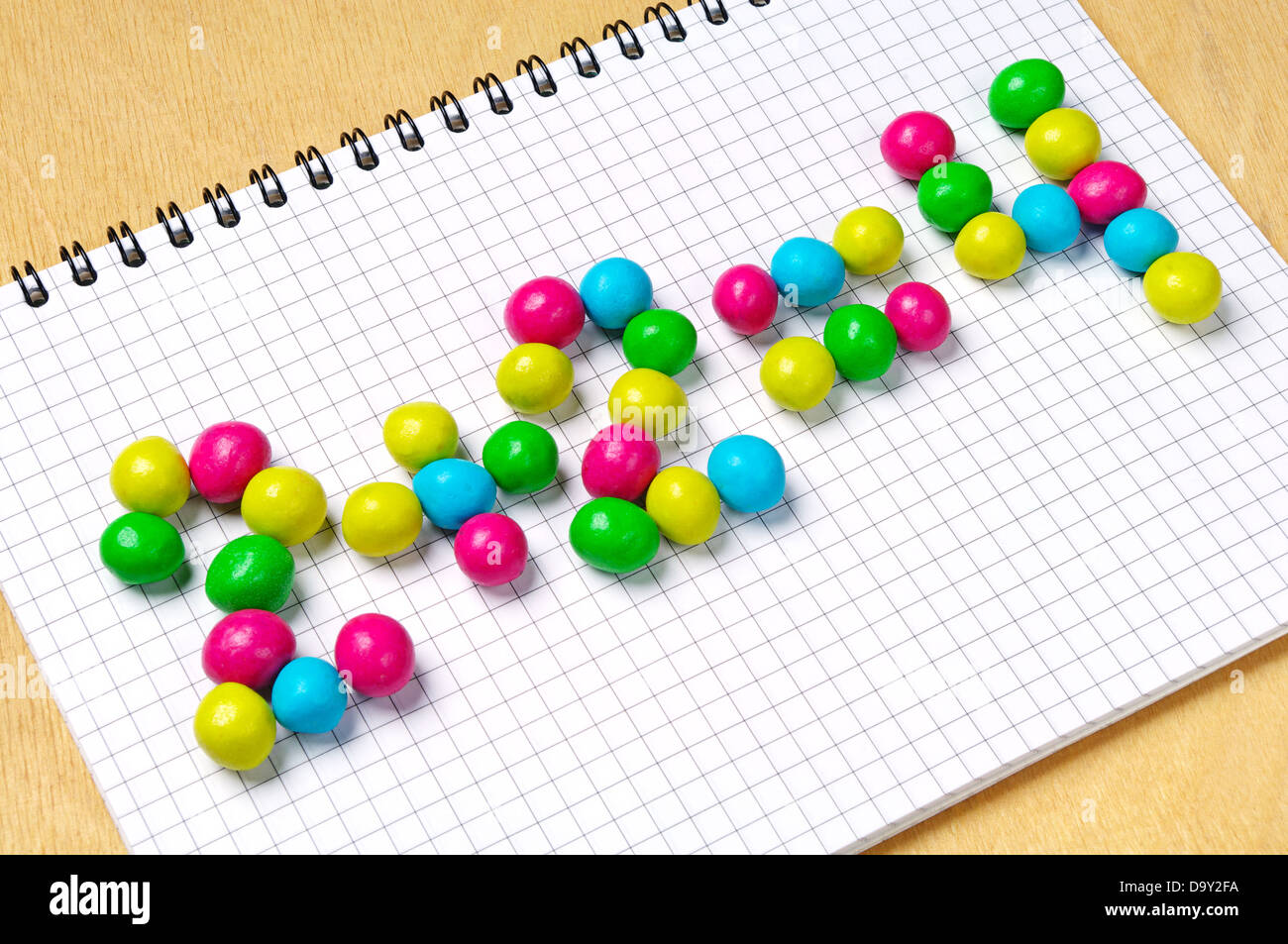 Numerals two plus two from colored candy Stock Photo - Alamy