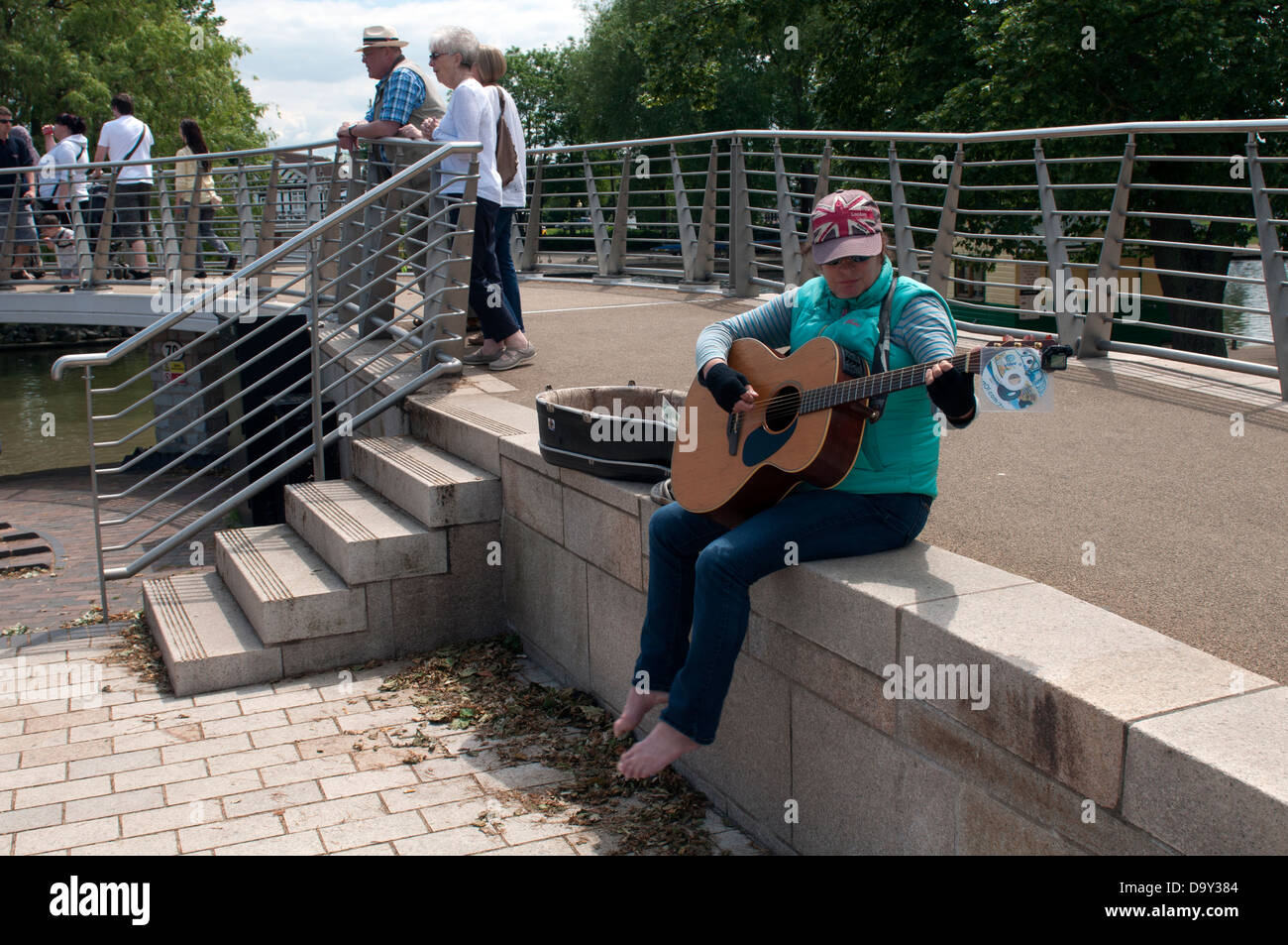 Woman playing guitar singing busking hi-res stock photography and ...