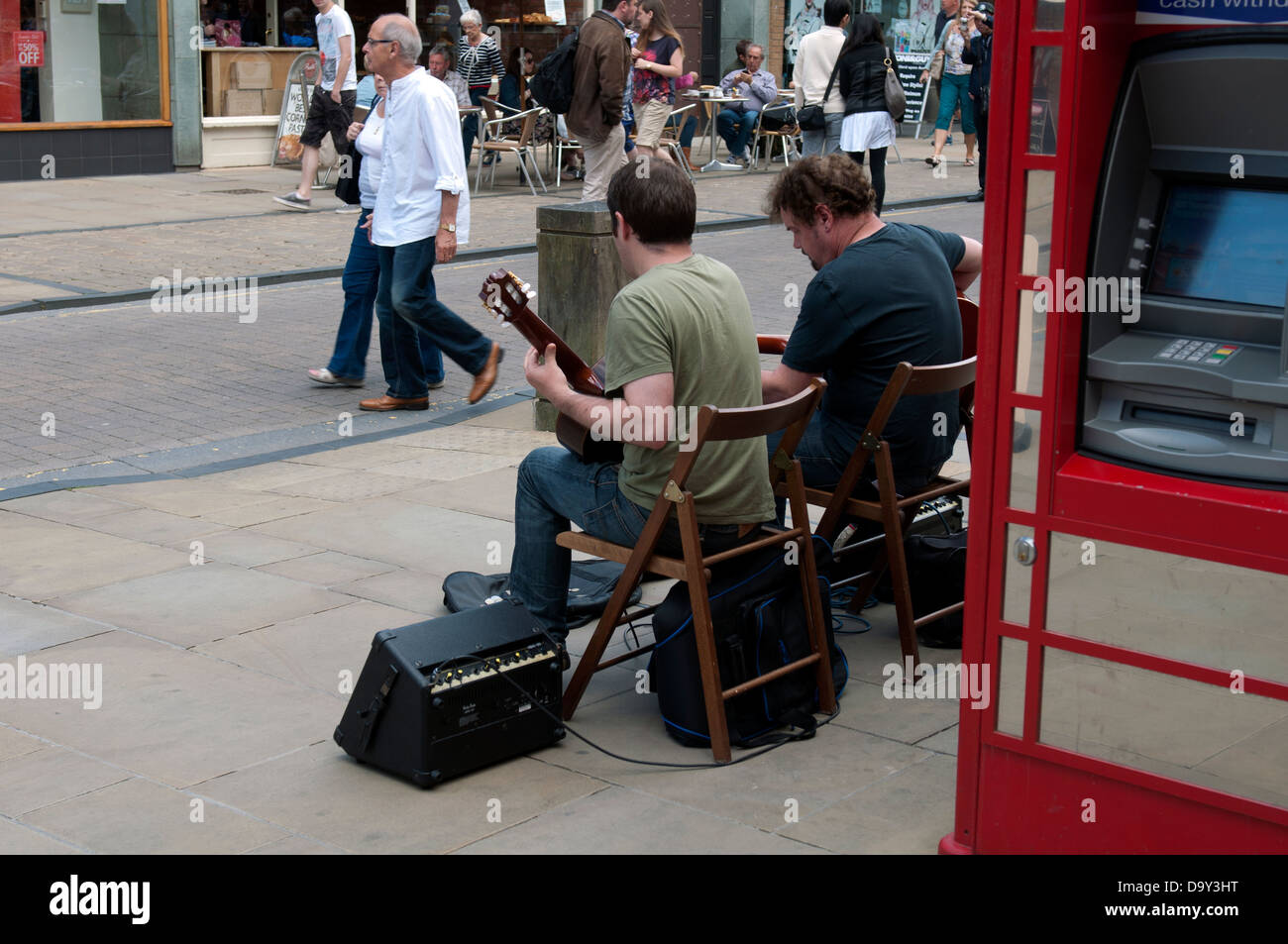 Busking guitars hi-res stock photography and images - Alamy