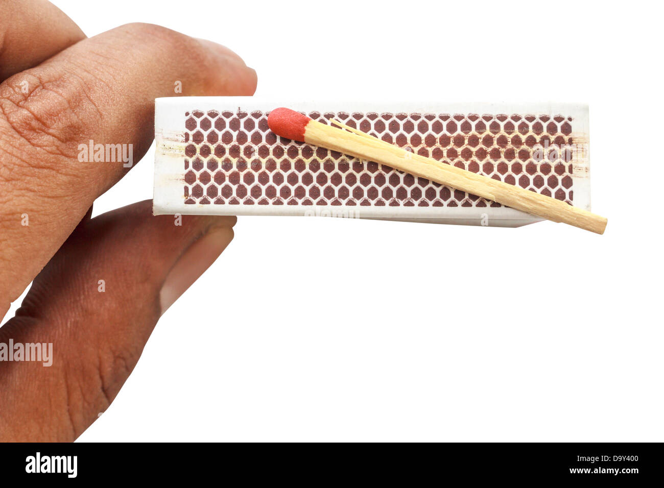 Match on matchbox with hand holding isolate Stock Photo - Alamy
