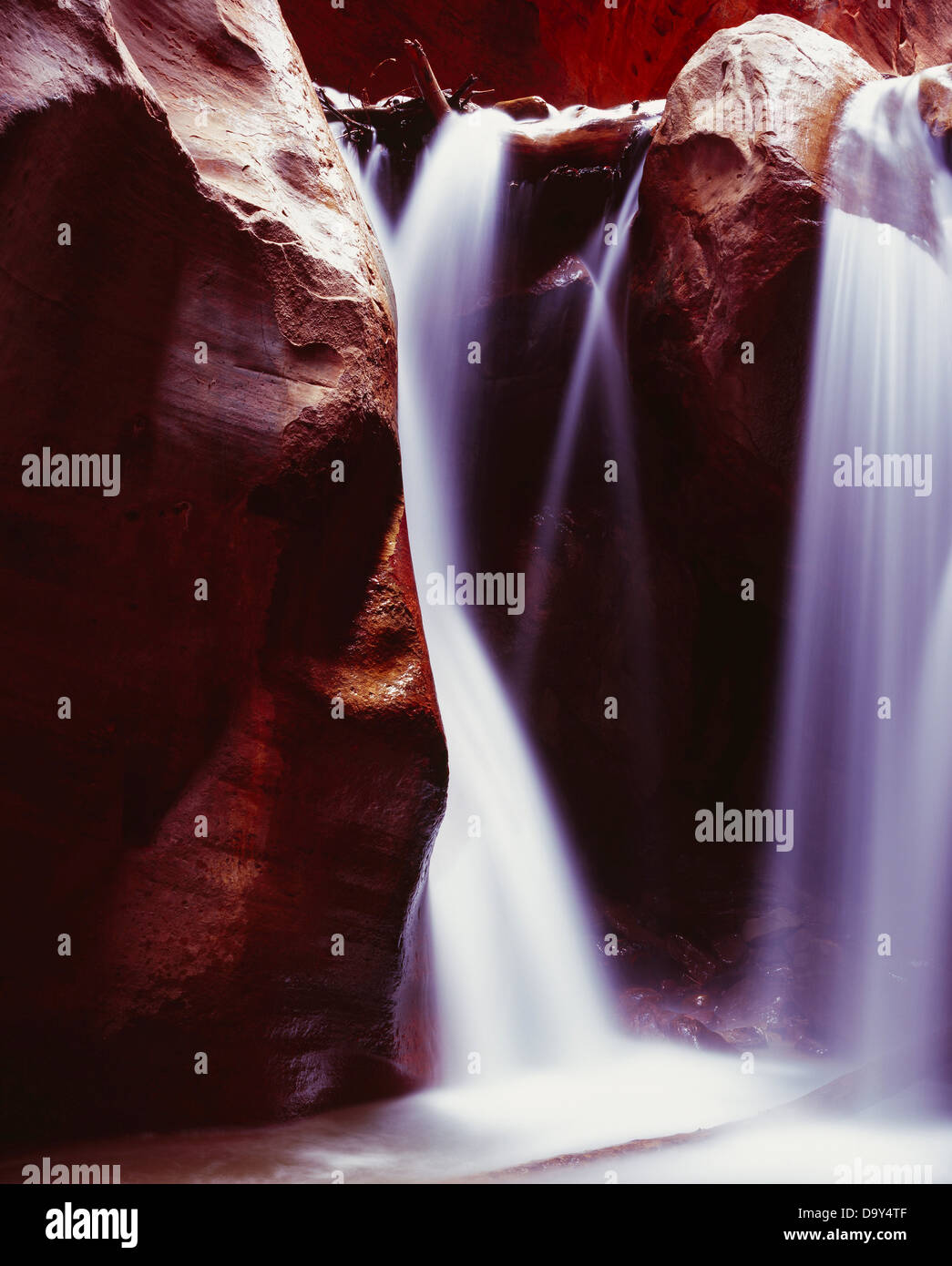 Kanarra Creek spilling over slickrock waterfall deep within a slot ...