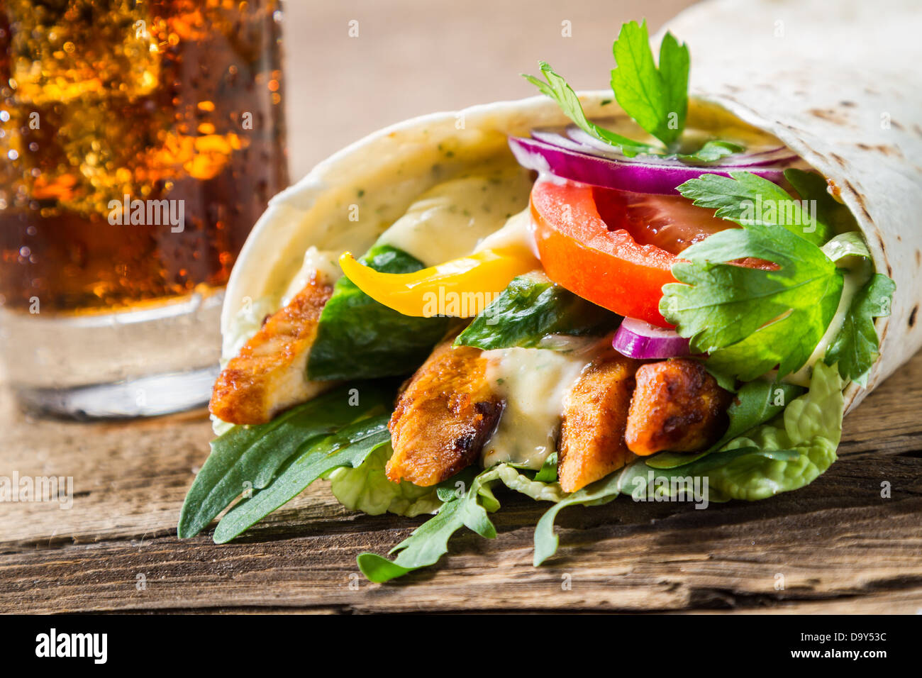 Closeup of kebab with fresh vegetables and chicken on black background ...