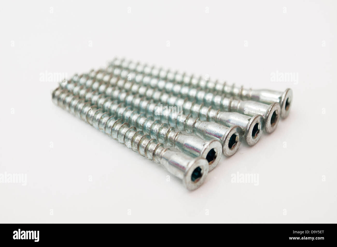 silver screws on a white background Stock Photo - Alamy