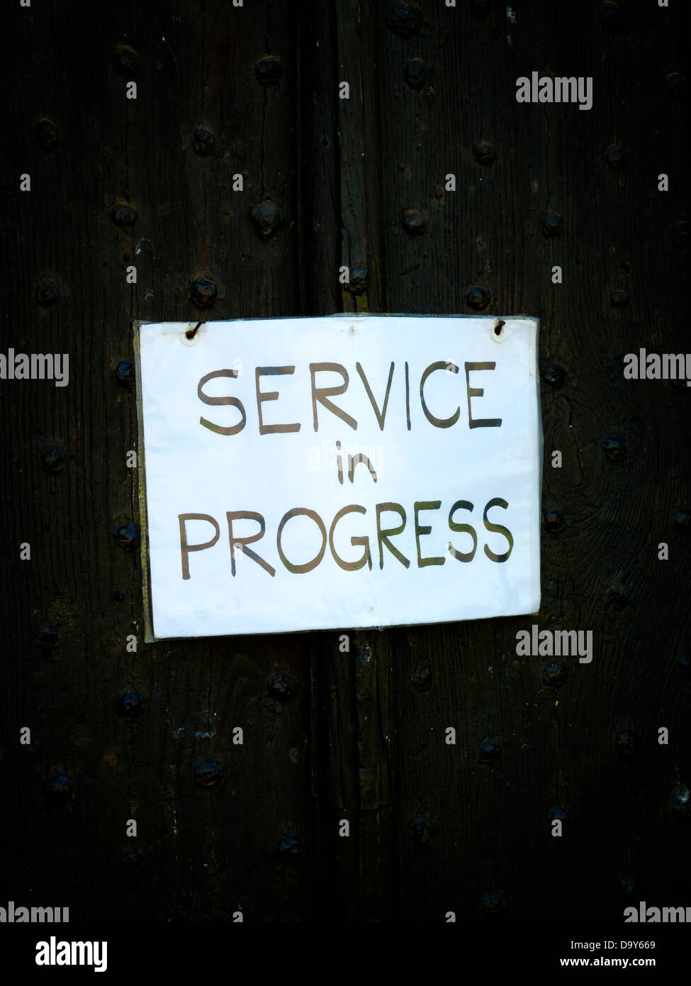 Service in Progress sign attached to a church door England UK Stock ...