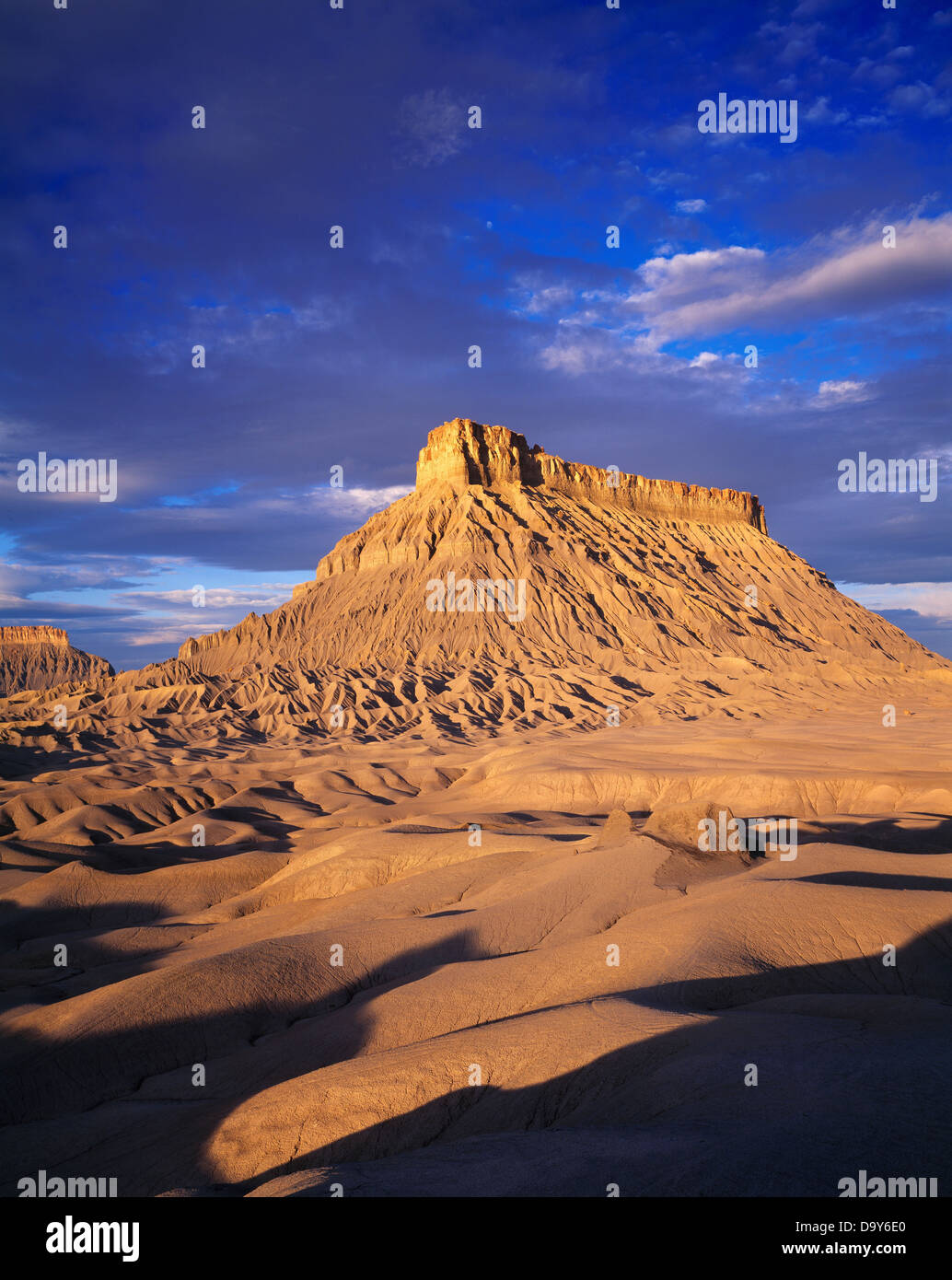 Morning light illuminating Factory Butte badlands Mancos shale capped ...