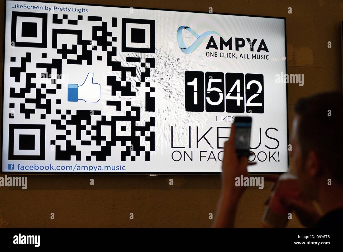 A guest scans a QR code of the Ampya record store, a new music platform ...