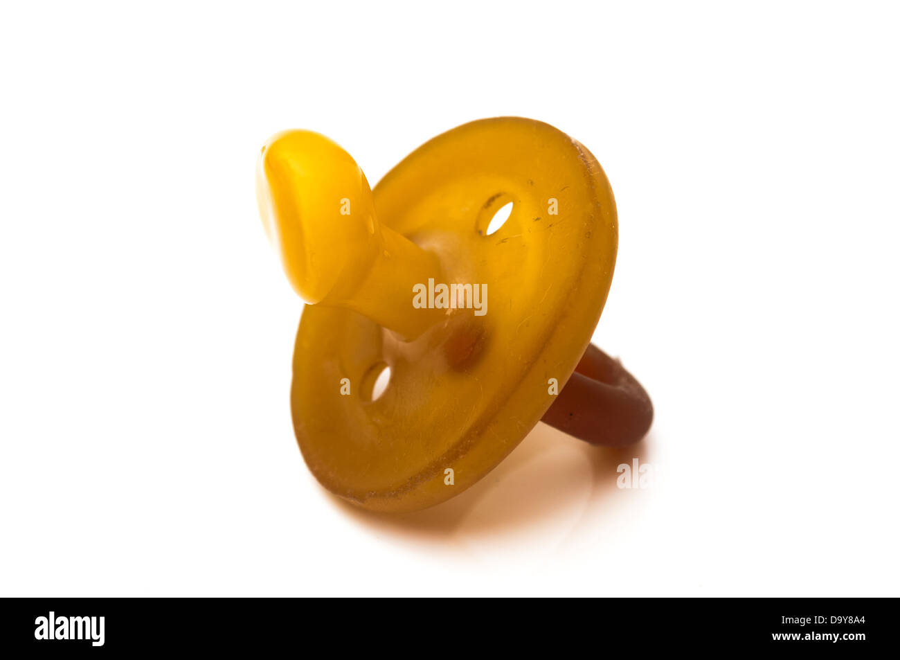 yellow pacifier on a white background Stock Photo - Alamy
