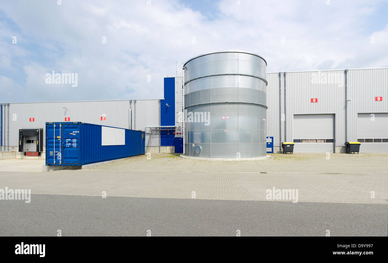 modern warehouse with containers and trucks in front Stock Photo - Alamy