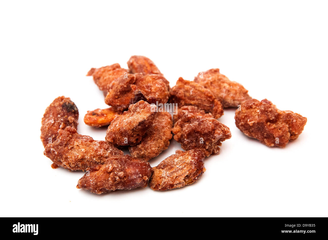 caramelized almonds on a white background Stock Photo - Alamy