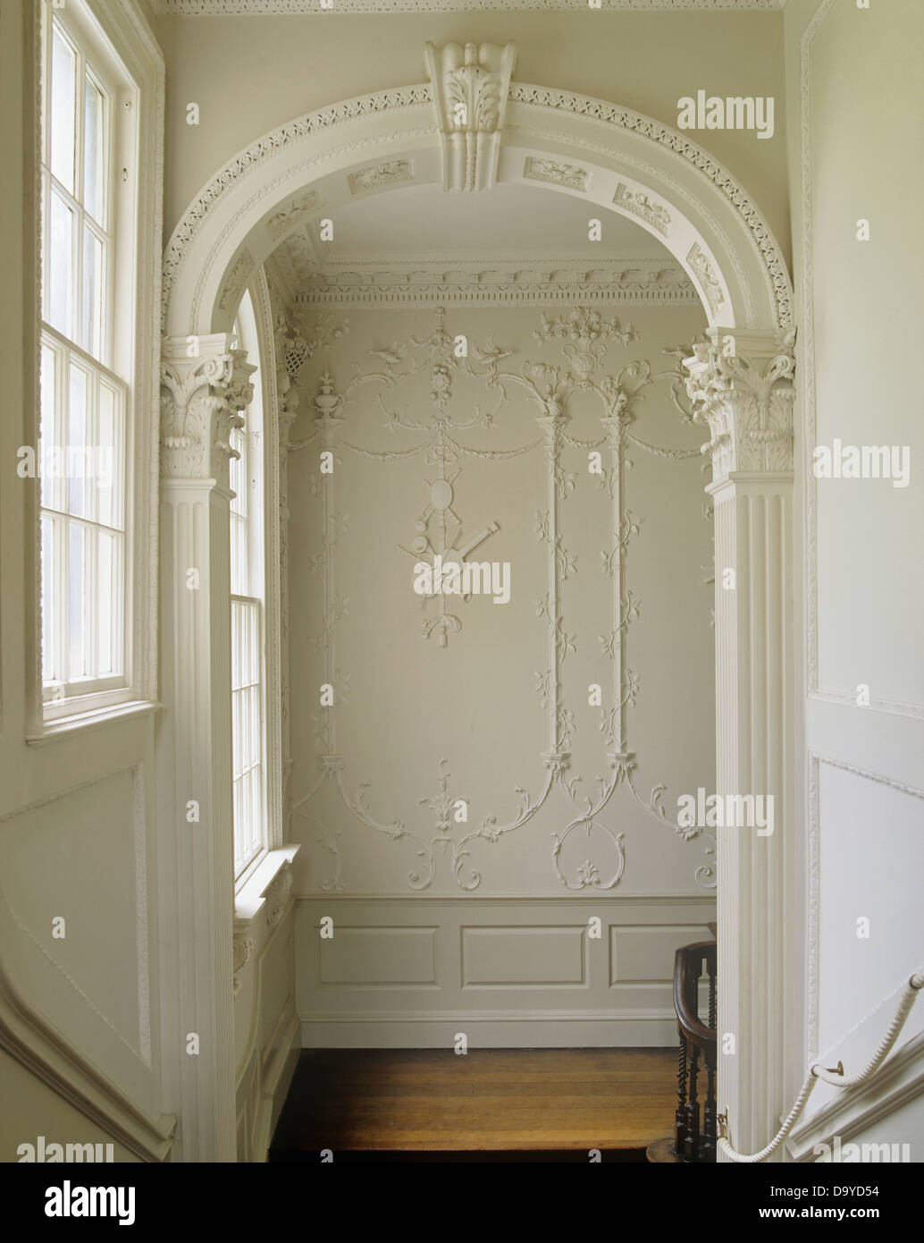 Grand archway and white walls with Rococo plasterwork in large country ...