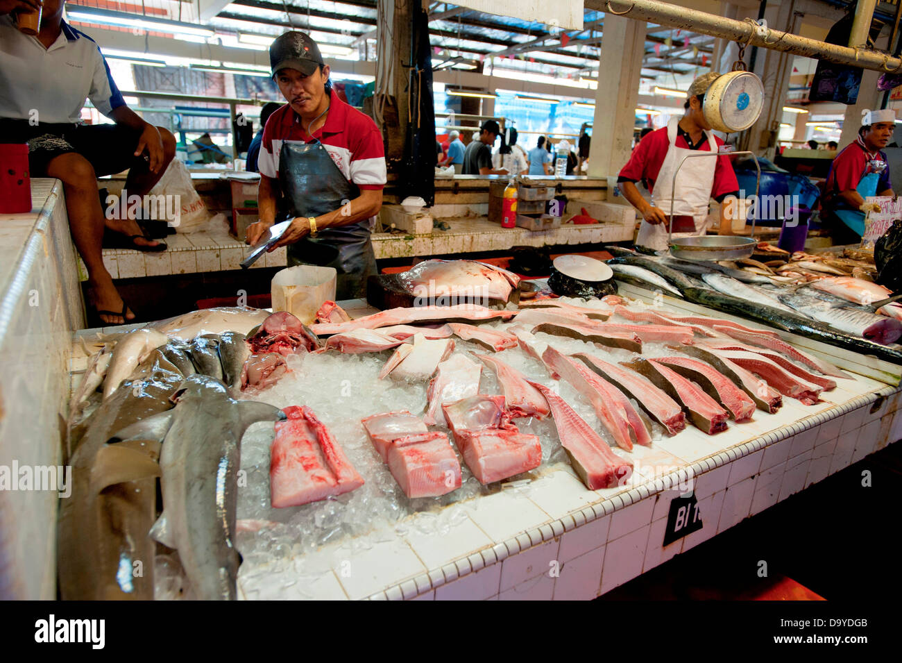 Man butchering fish and rays in the market, Brunei Stock Photo - Alamy
