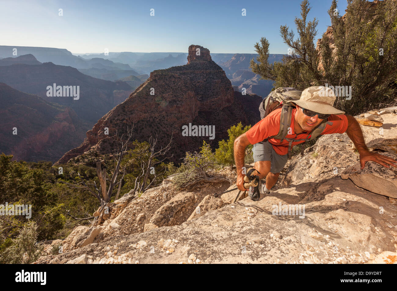 A man scrambling on a trail Stock Photo - Alamy