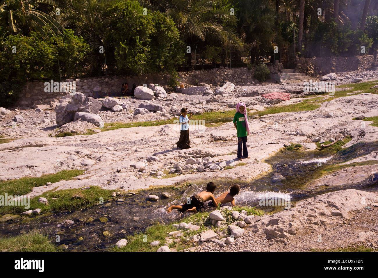 Kids play in the warm waters of Ath-Thowra springs, Nakhal, Oman Stock ...