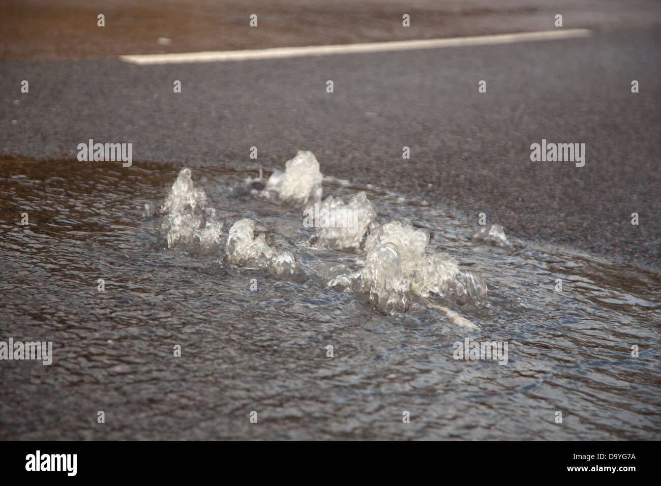 Overflowing drain in road Stock Photo - Alamy