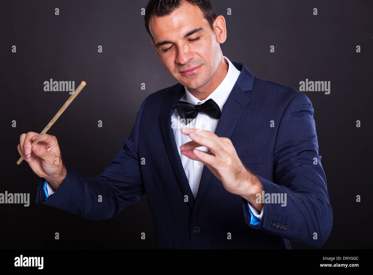 male conductor on black background Stock Photo - Alamy