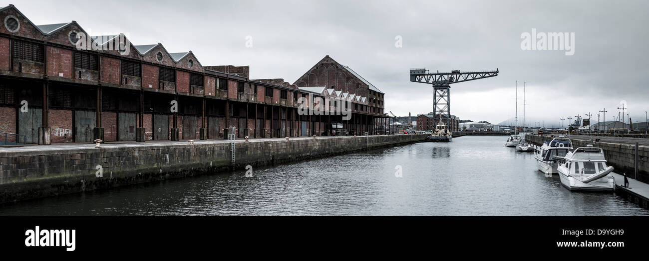 Victorian industrial dock containing warehouses and leisure craft and a ...