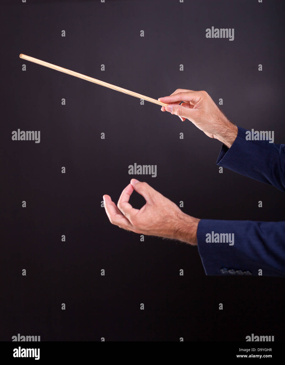 hands of the conductor on black background Stock Photo - Alamy