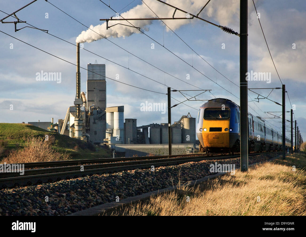 High speed passenger train passing a cement factory near Dunbar on the ...