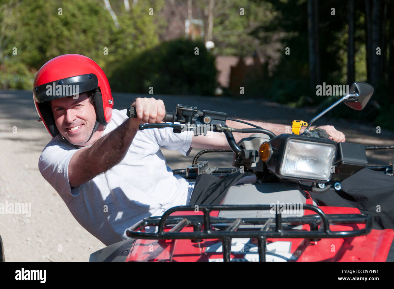 young man riding a Quad in Quebec rural road, Canada Stock Photo - Alamy