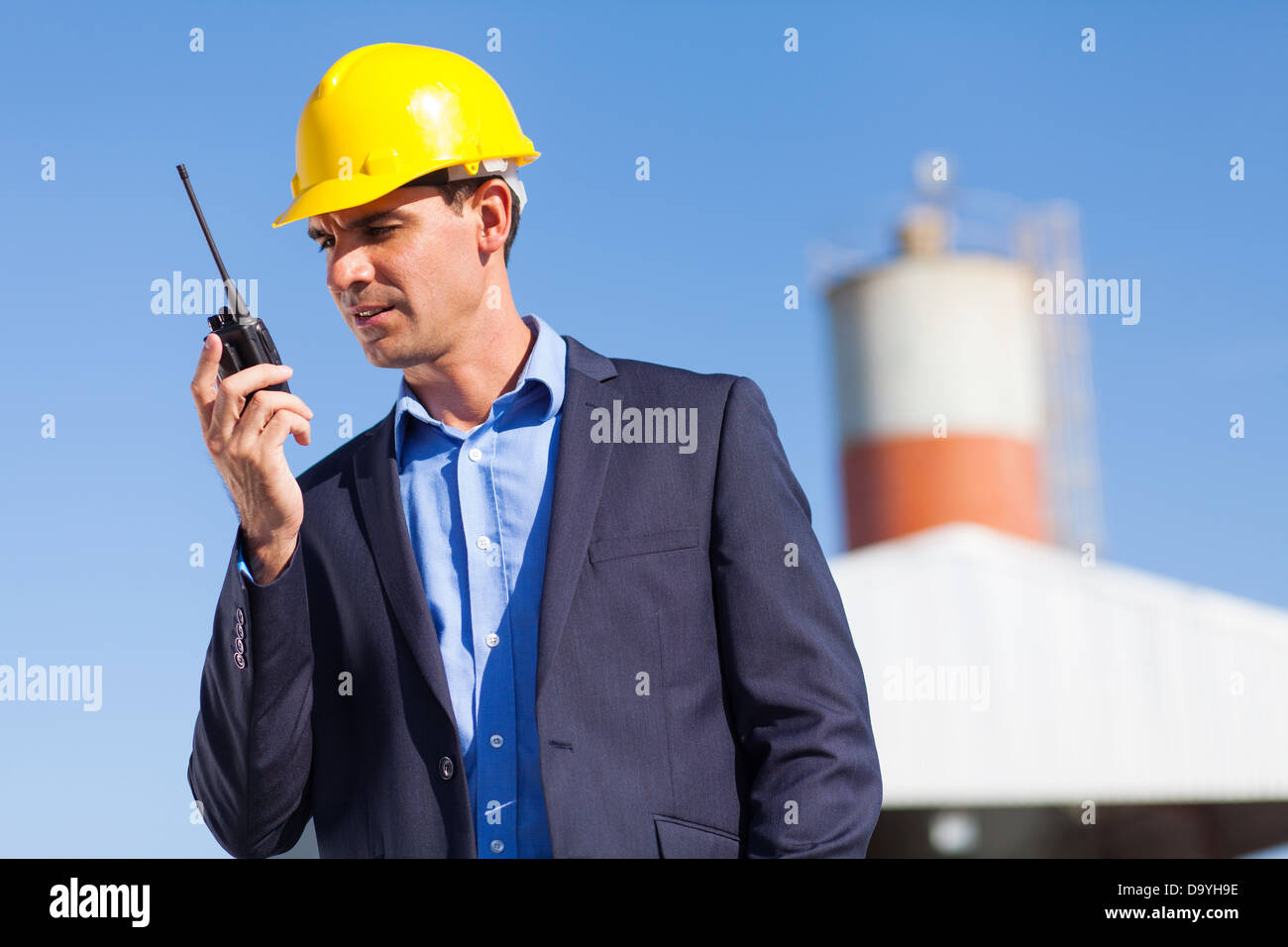 handsome construction manager using walkie talkie outdoors Stock Photo ...