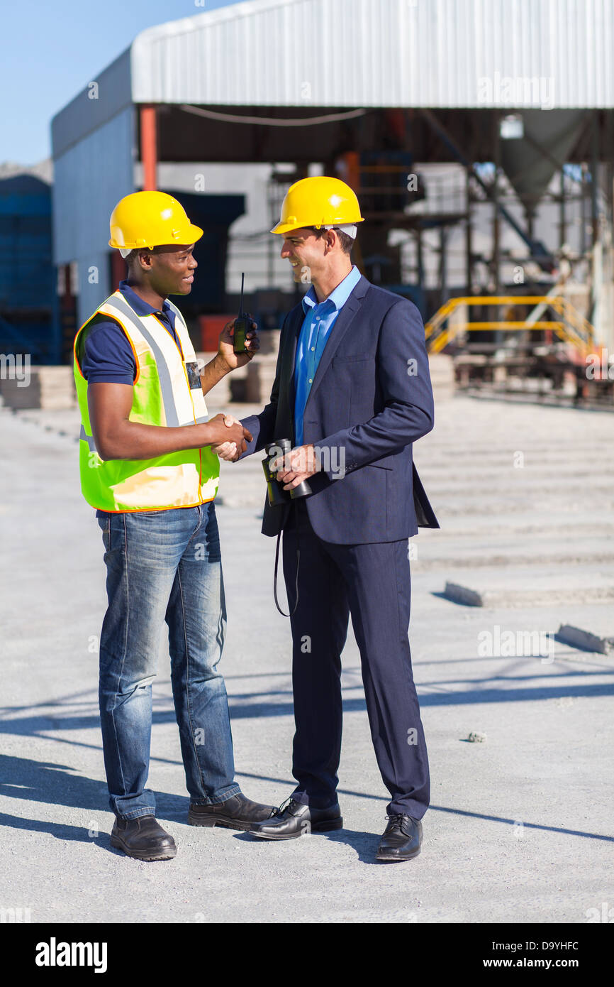 construction manager and worker handshake on site Stock Photo - Alamy