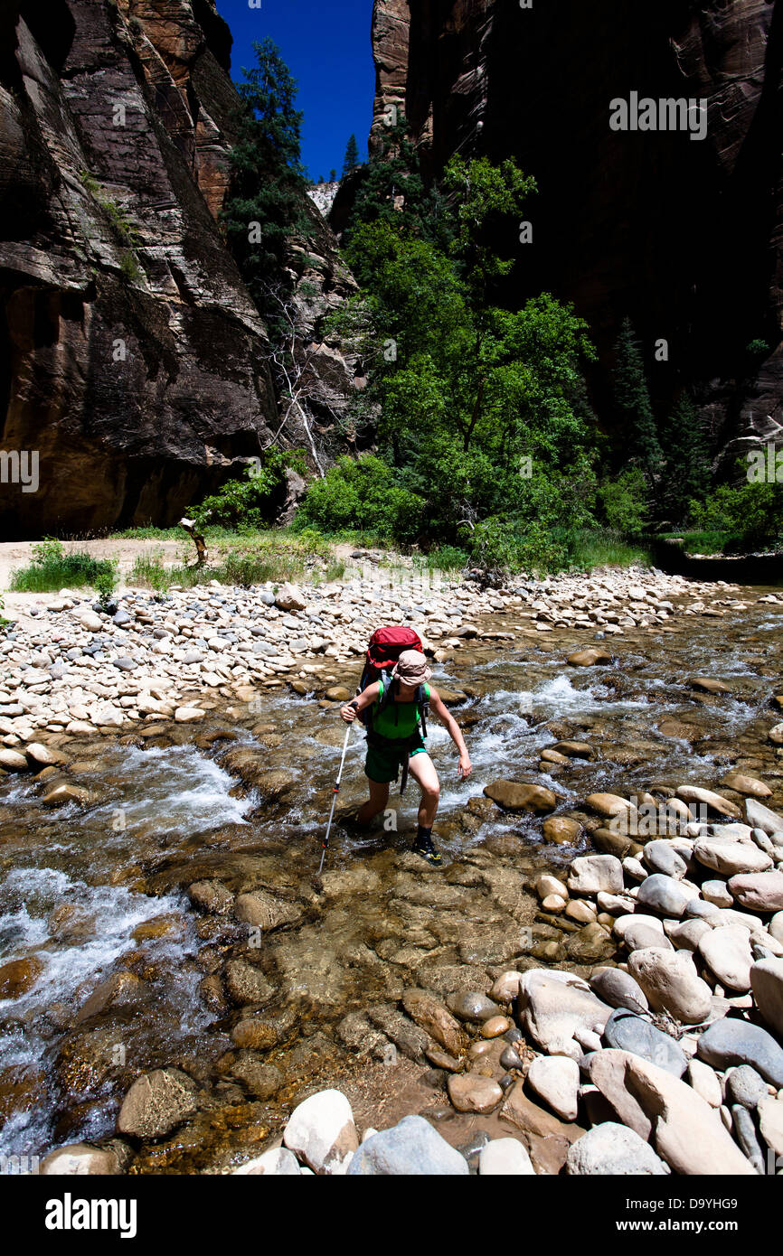 Woman wading through river hi-res stock photography and images - Alamy