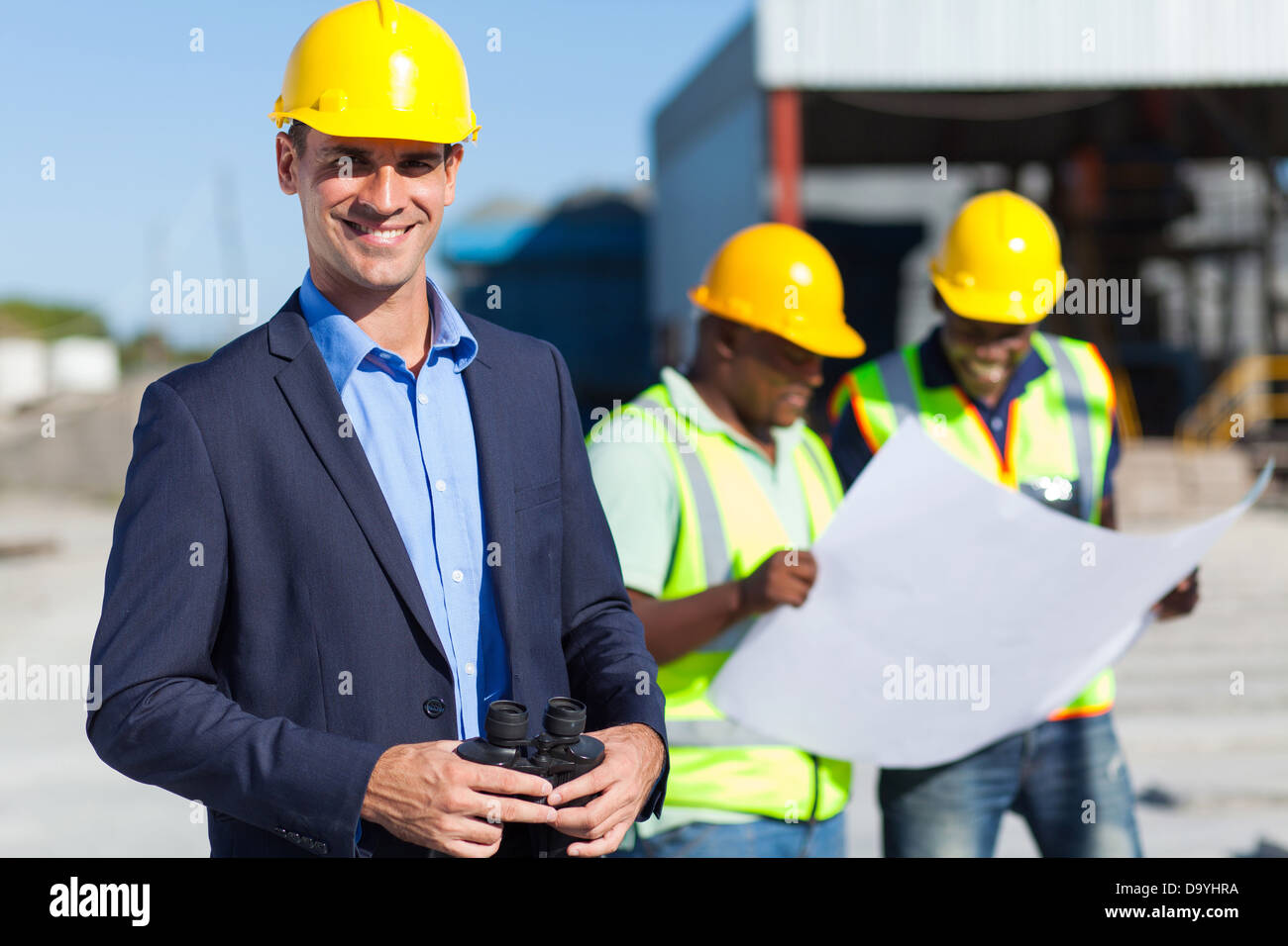smiling Caucasian construction supervisor with binoculars Stock Photo ...