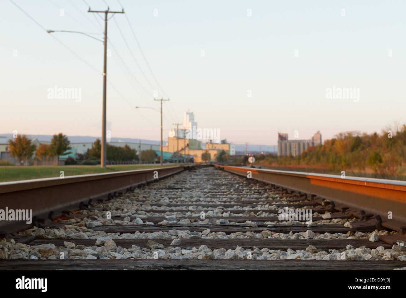 Railroad tracks leading towards industrial buildings Stock Photo - Alamy
