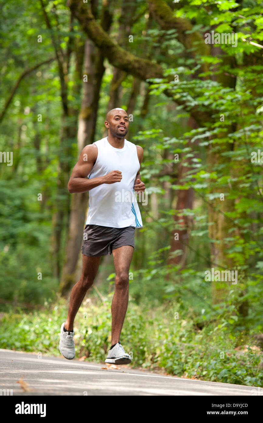 Young african american man running in city park Stock Photo - Alamy