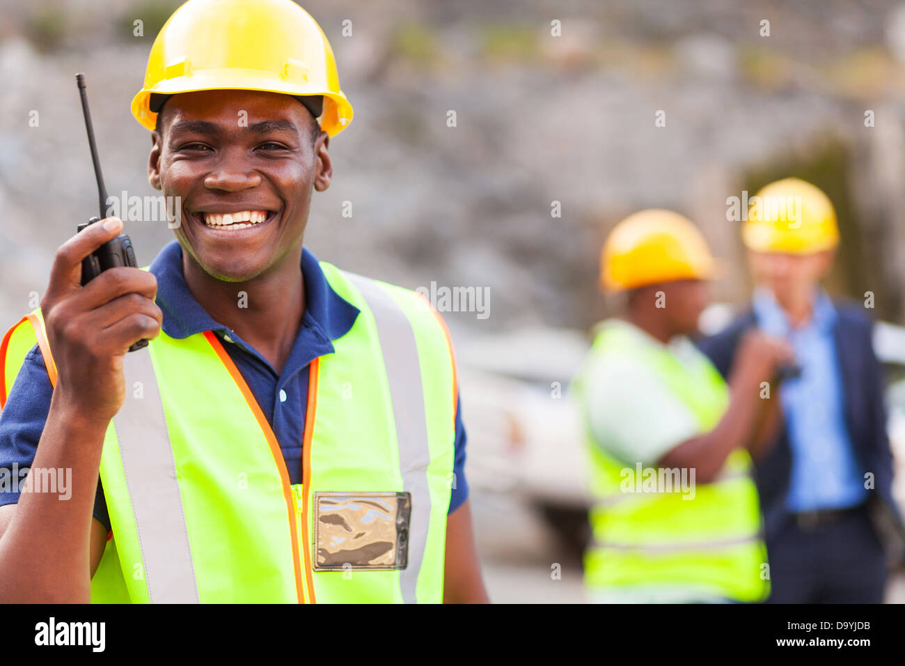 cheerful afro American mine worker with walkie talkie Stock Photo - Alamy