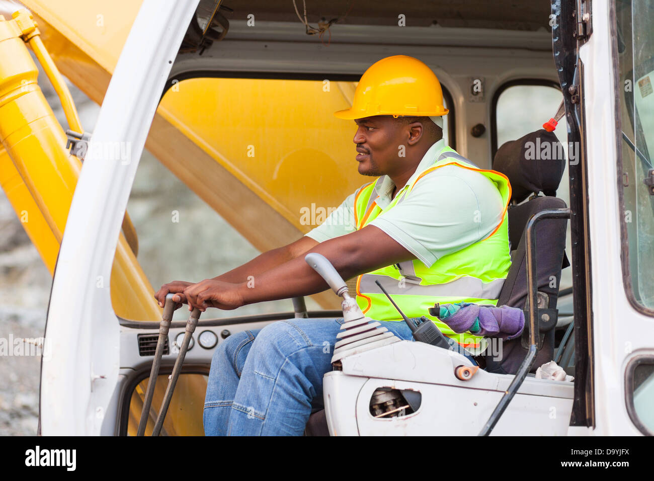 African American man operates excavator on building site Stock Photo ...
