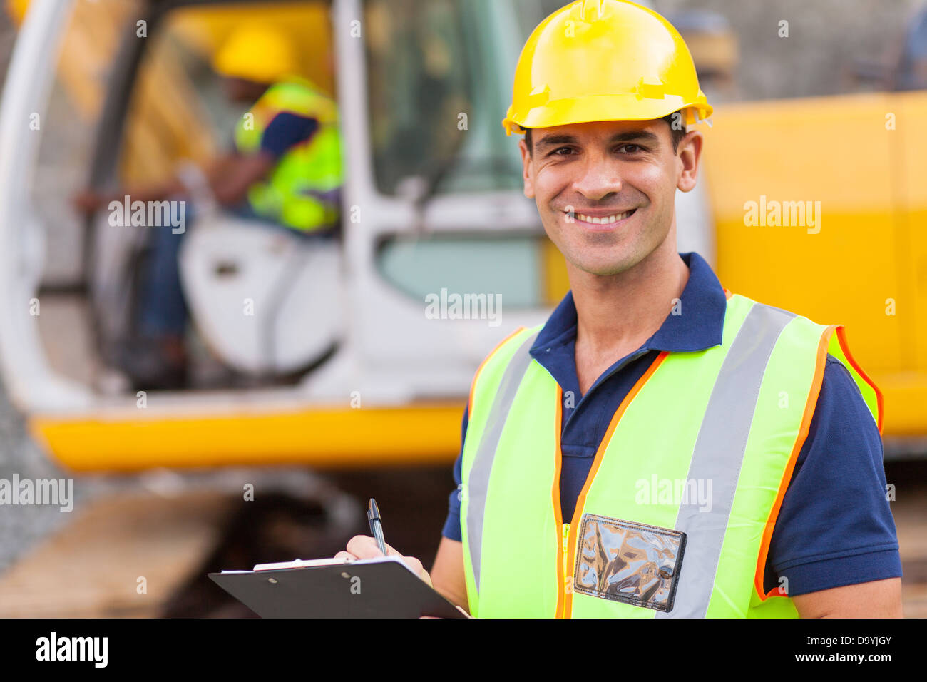 handsome road construction supervisor with clipboard Stock Photo - Alamy